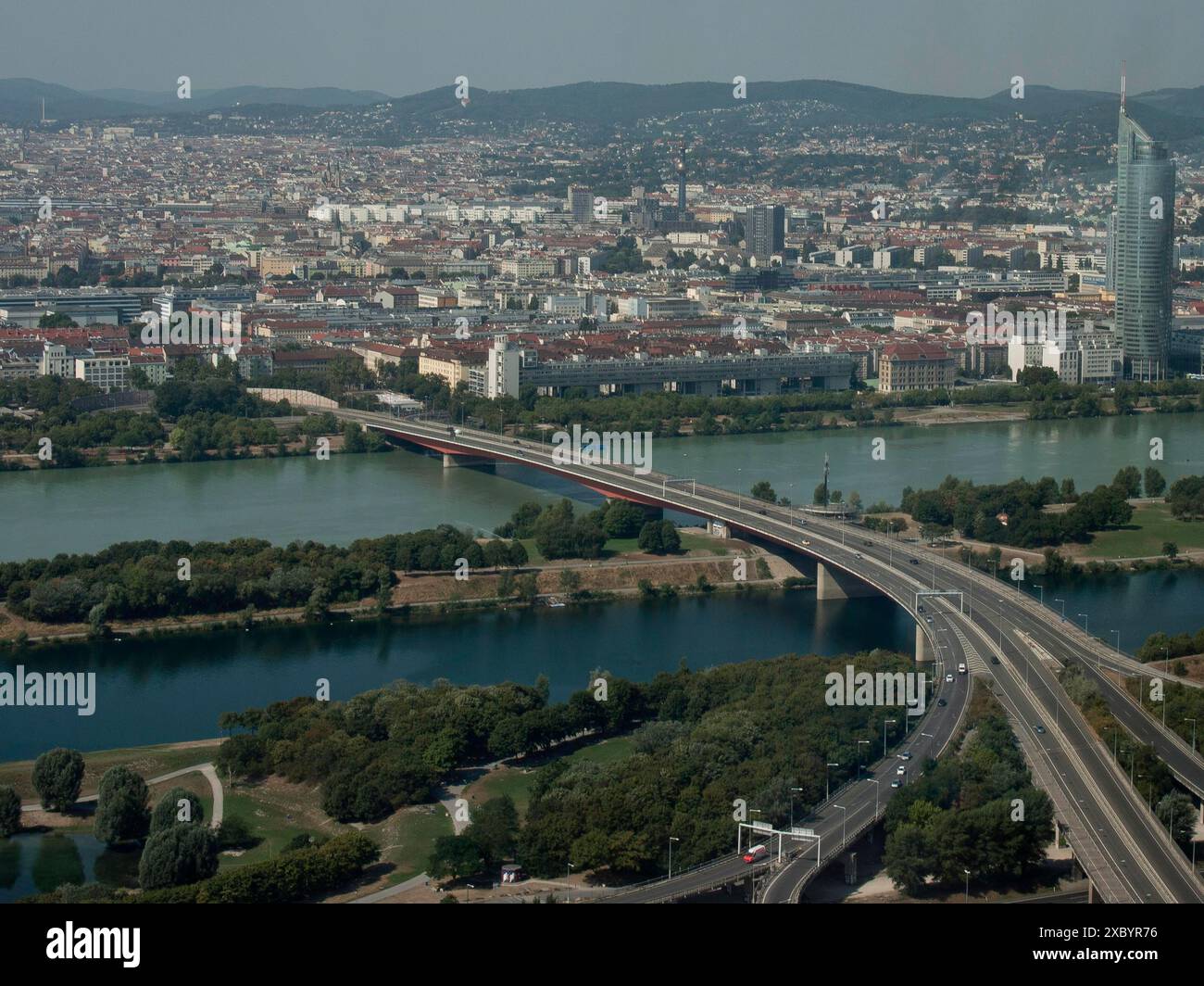 Expansive city view with rivers, bridges and mountains visible in the background, Vienna ...