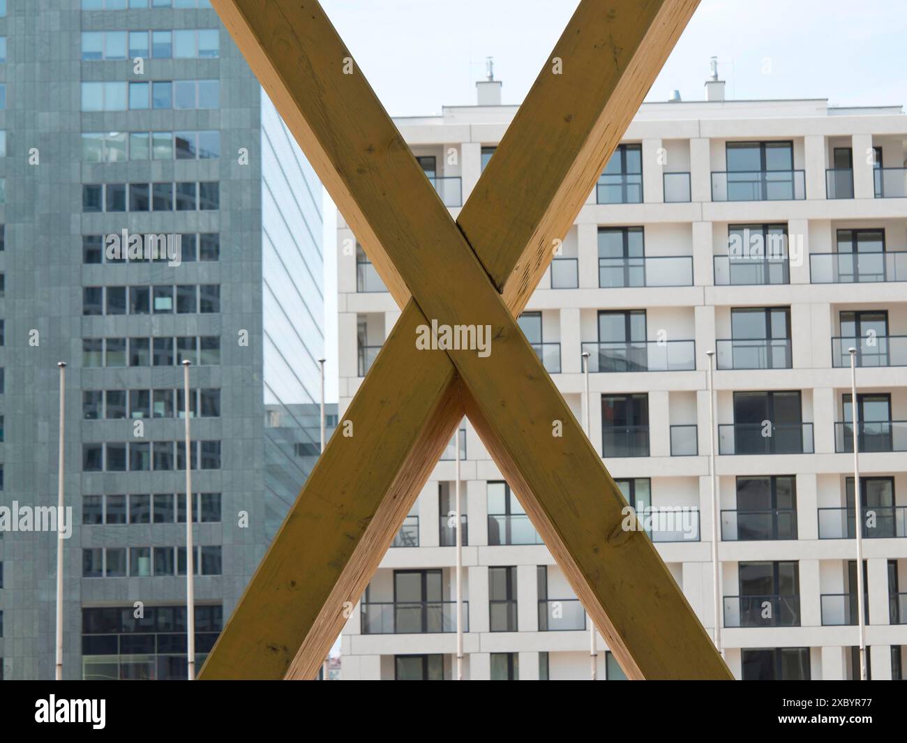 X-shaped timber constructions in front of a modern office building with ...
