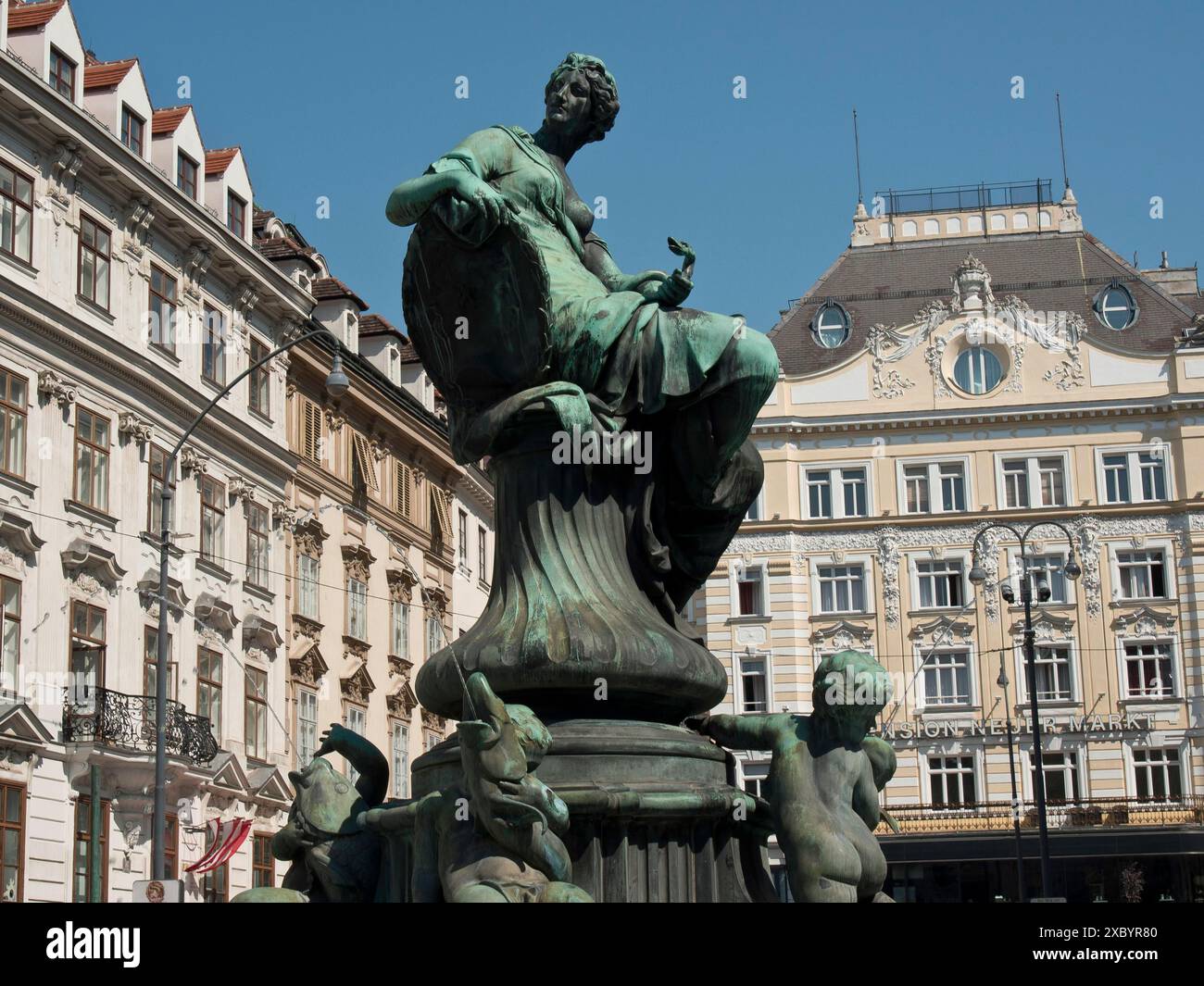 A bronze statue in an urban environment in front of historic buildings ...
