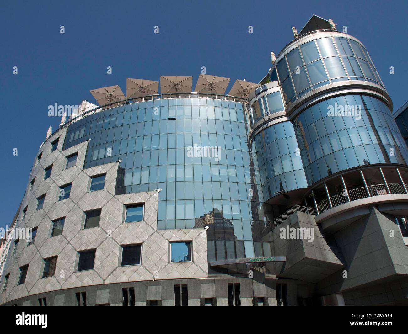 A large modern building with geometric patterns and blue glass windows ...