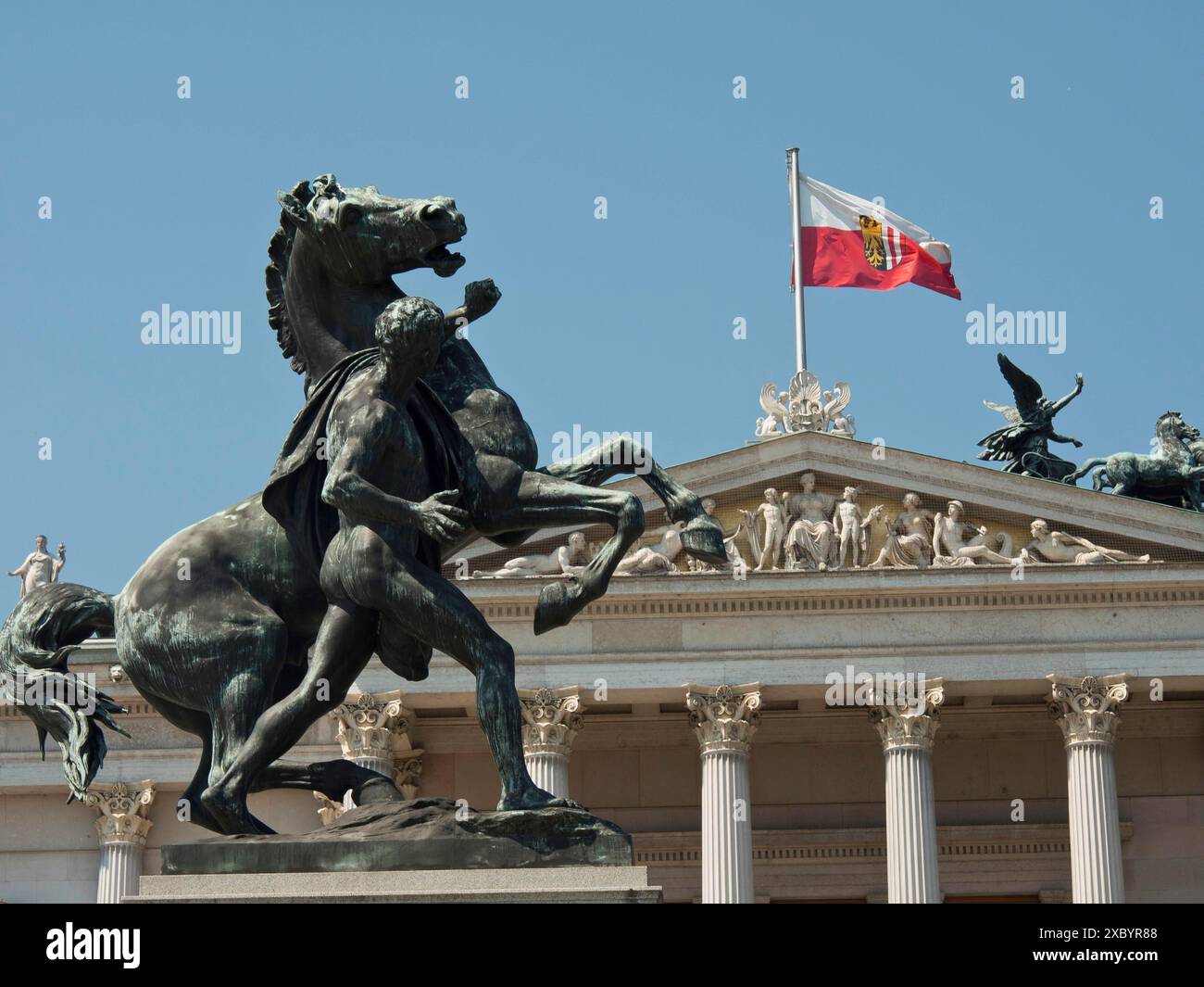 A dramatic equestrian statue in battle in front of a historic building ...