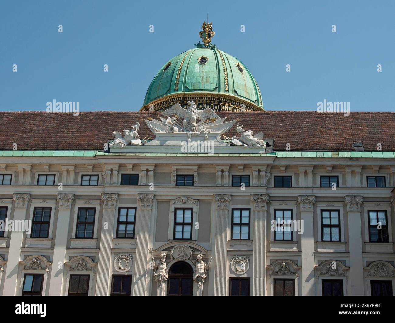 Historic baroque building with copper-green dome and roof ornaments ...