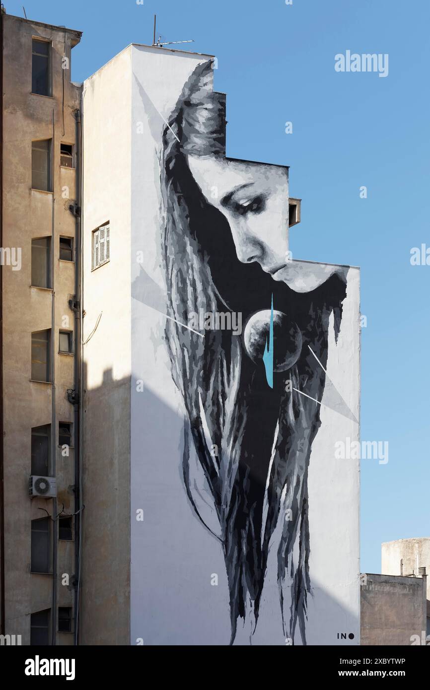 Woman with long hair looking at globe, mural in black and white by ...