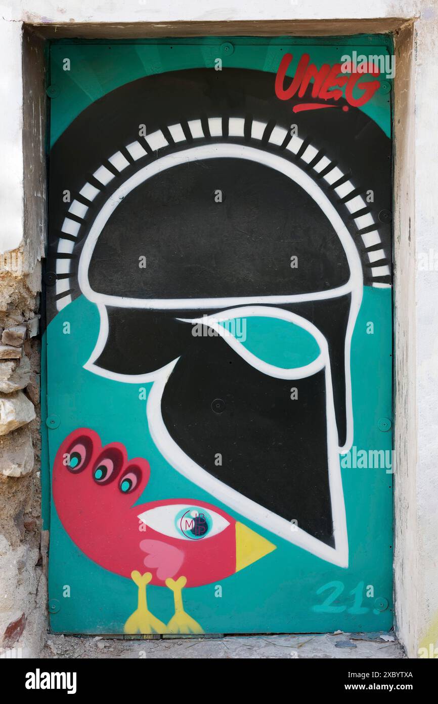 Greek helmet and bizarre bird, graffiti by street artist Uneg, Plaka ...