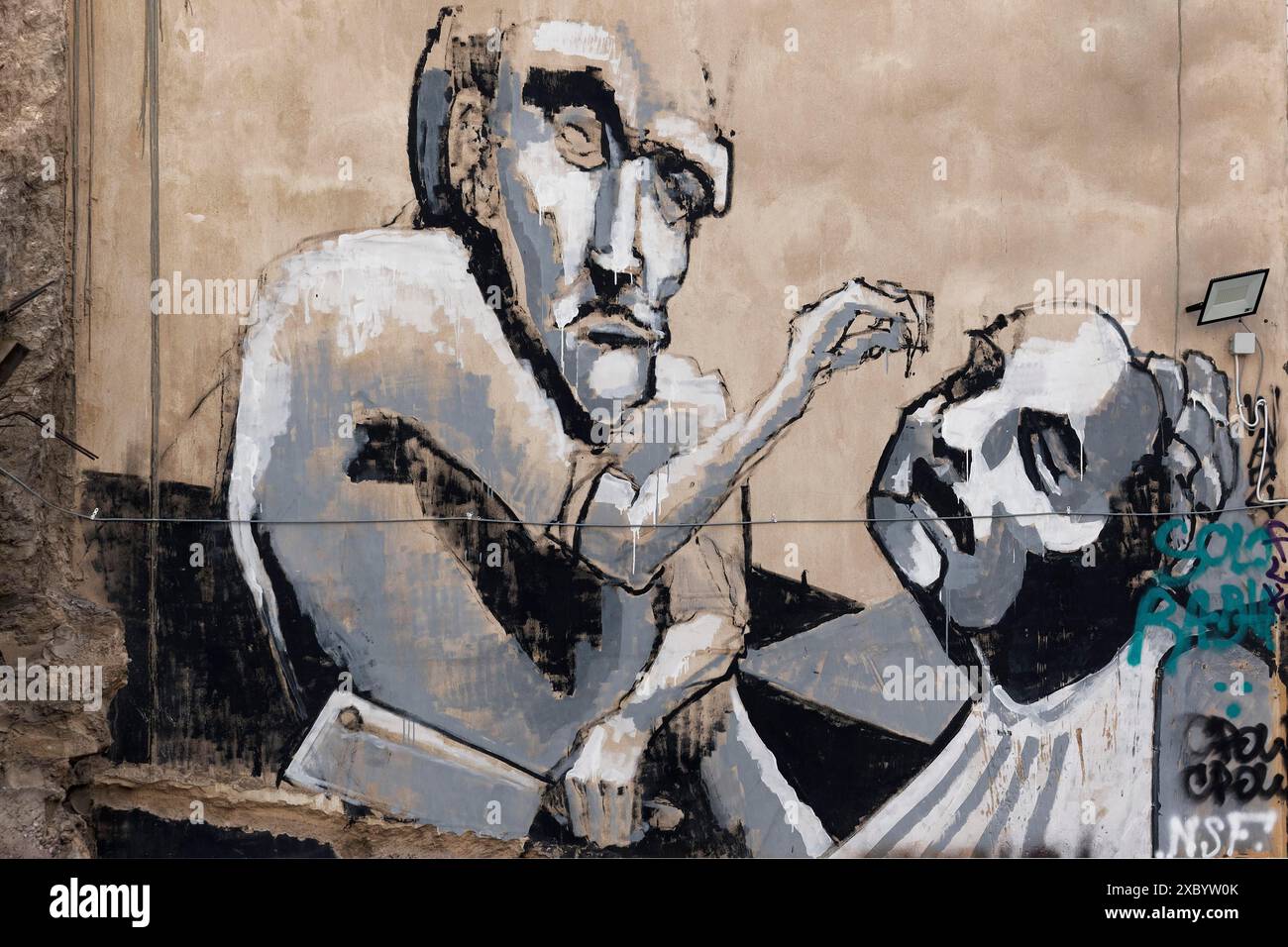 Figure with cleaver rips out man's tooth, graffiti in Exarchia ...