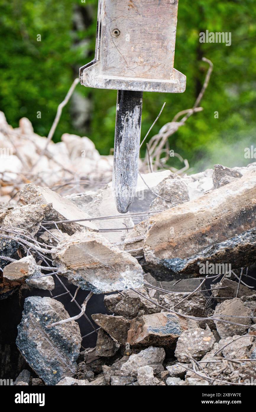 Close-up of an excavator breaking up concrete on the construction site ...