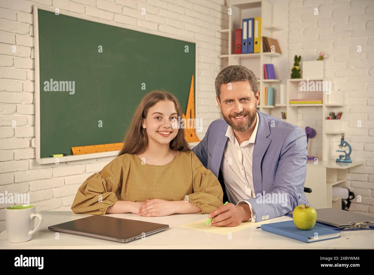 happy child study in classroom with tutor Stock Photo - Alamy
