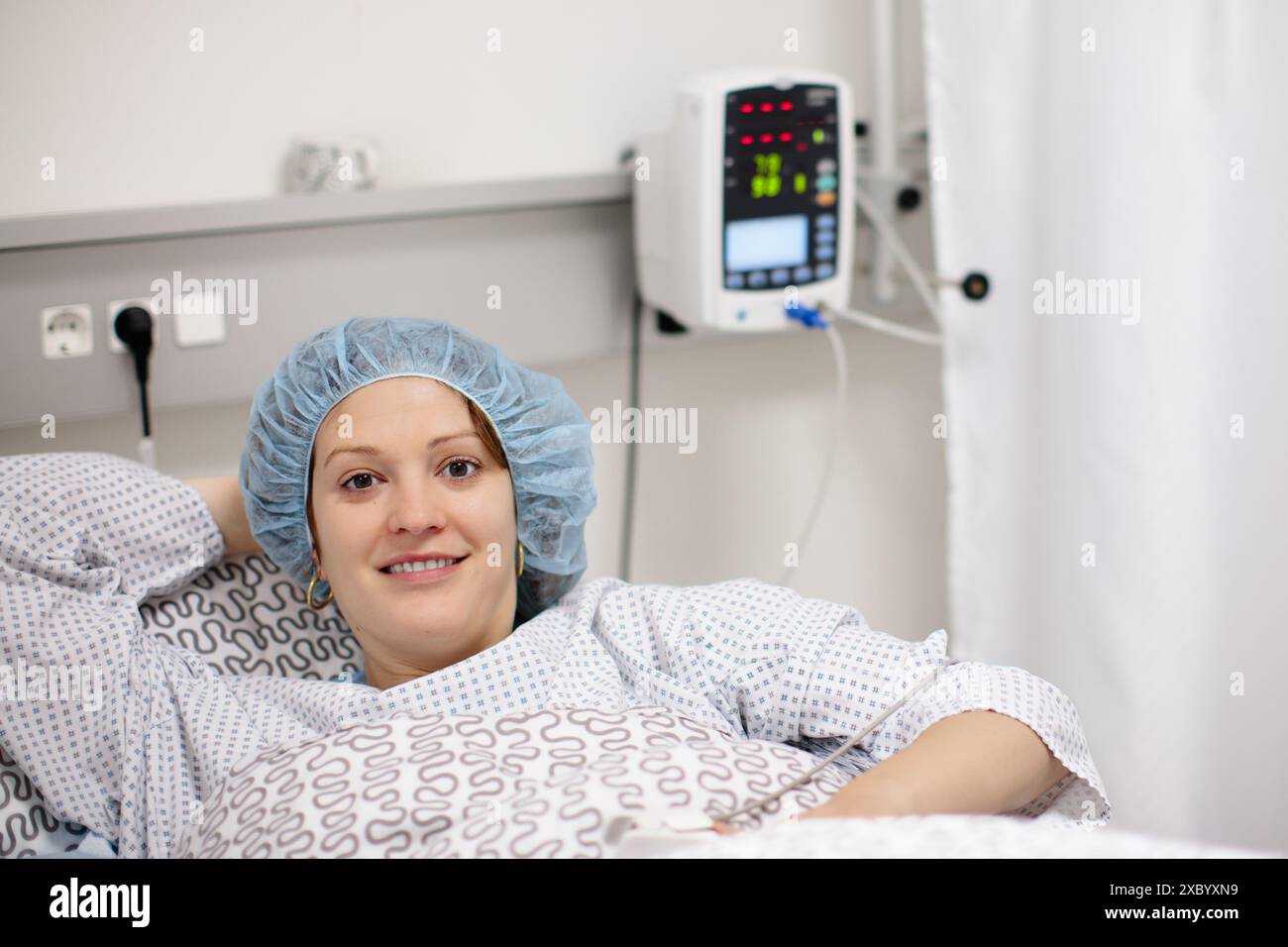 Young patient recovering after surgery in post operative care room in ...