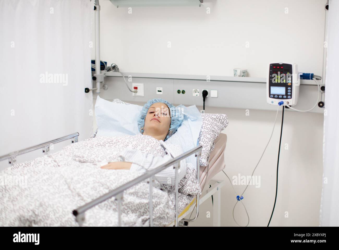 Young patient recovering after surgery in post operative care room in ...