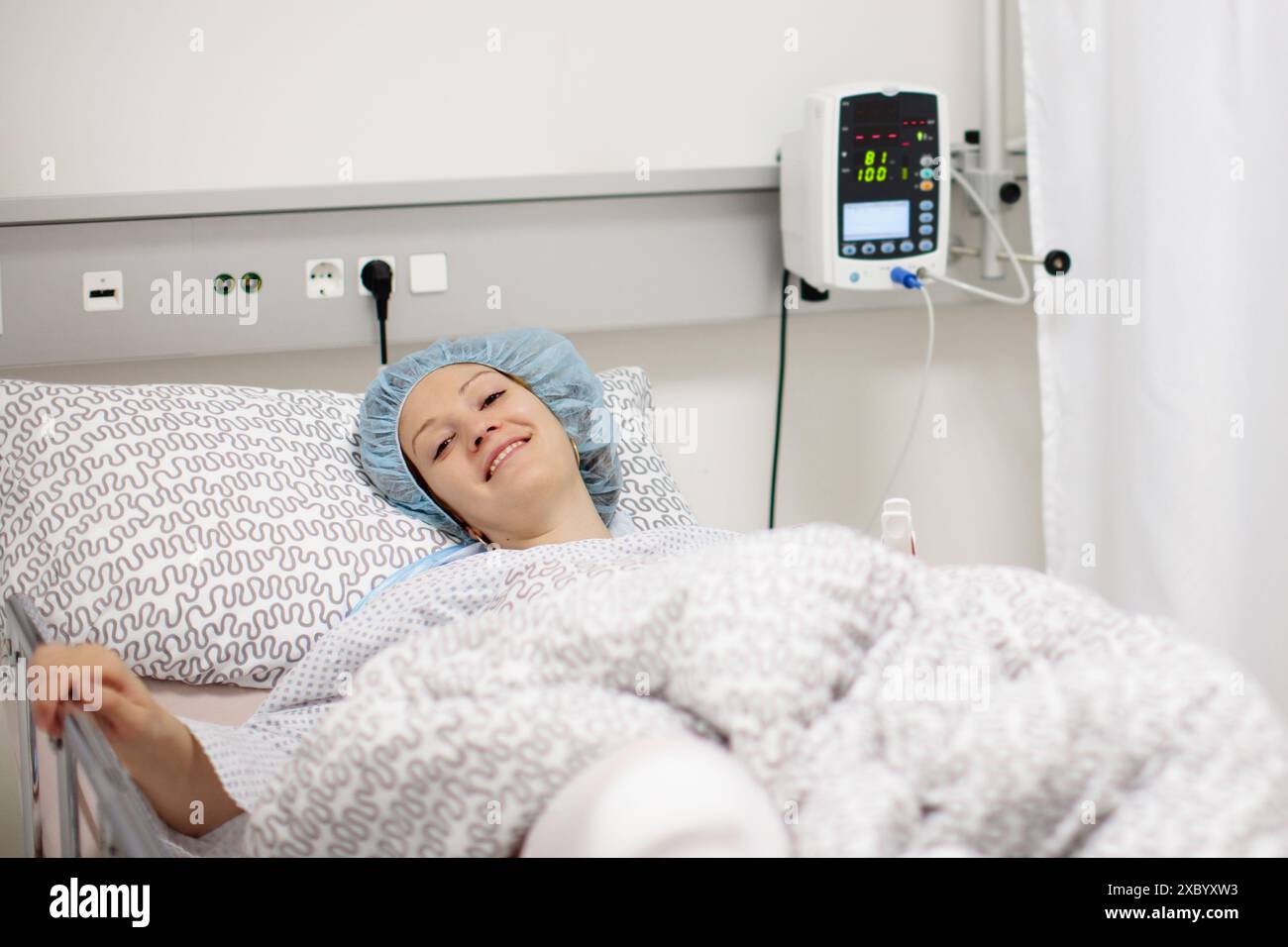 Young patient recovering after surgery in post operative care room in ...