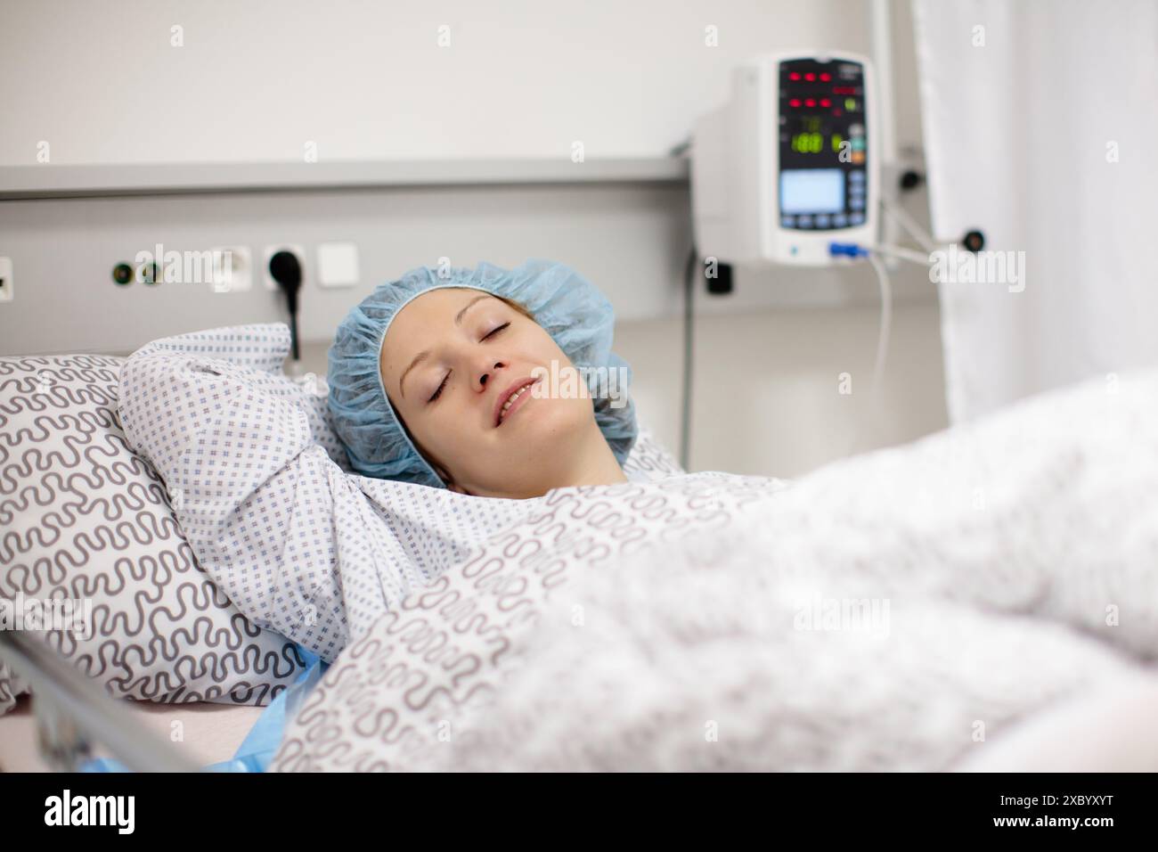 Young patient recovering after surgery in post operative care room in ...