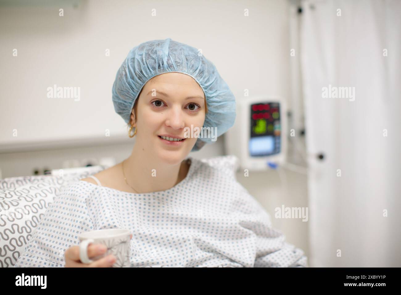 Young patient recovering after surgery in post operative care room in ...