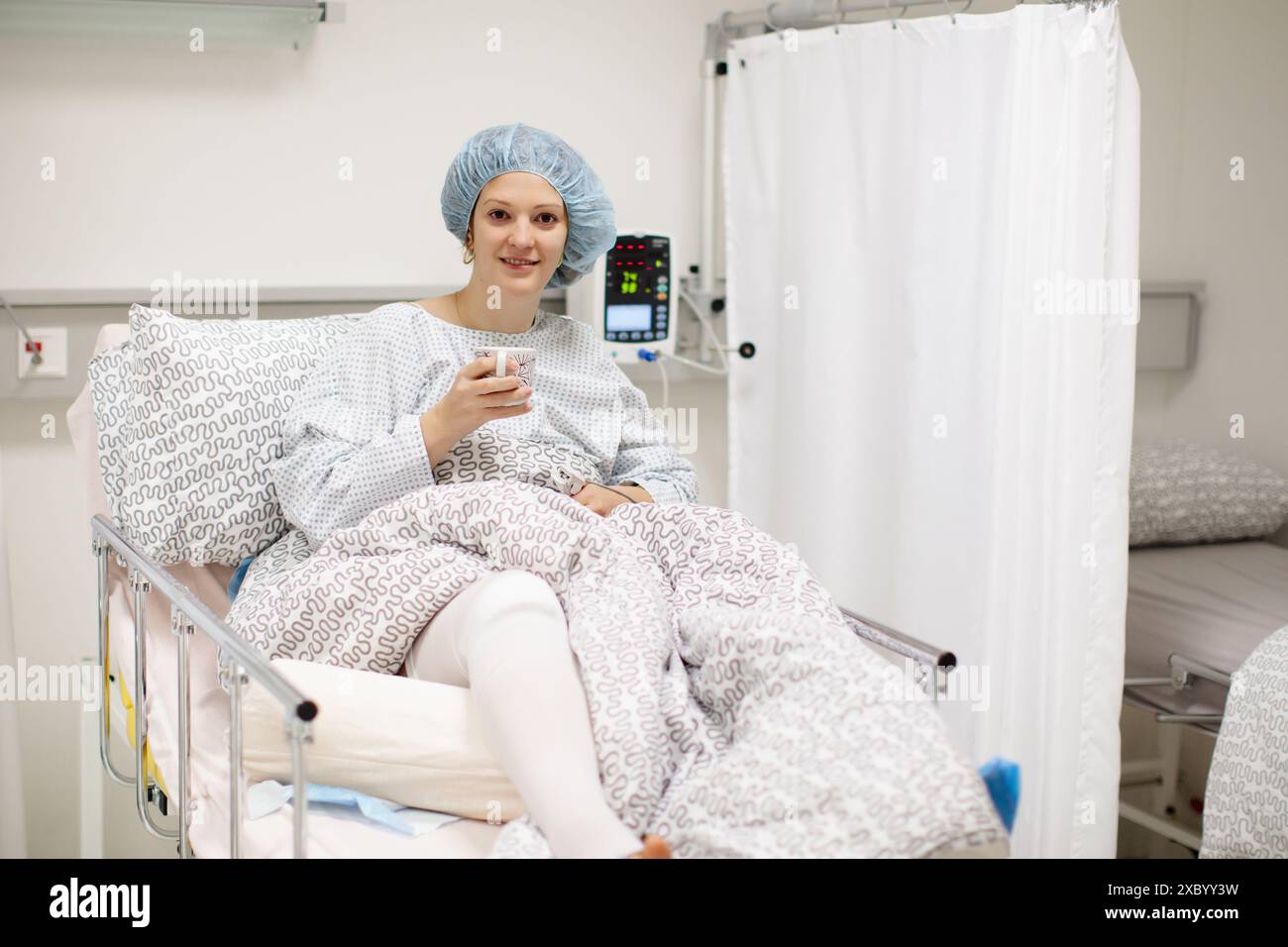Young patient recovering after surgery in post operative care room in ...