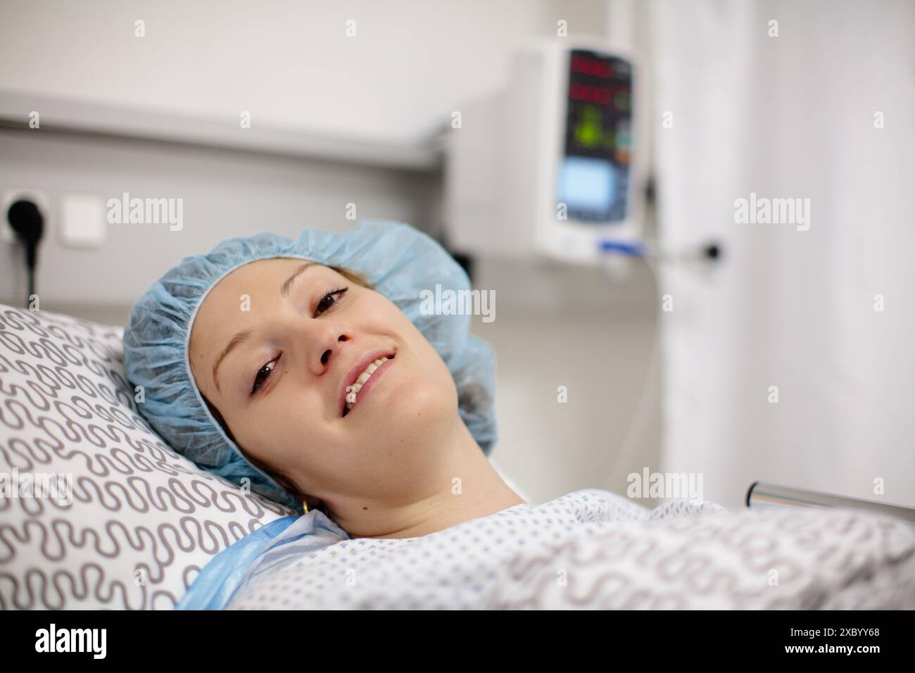Young patient recovering after surgery in post operative care room in ...