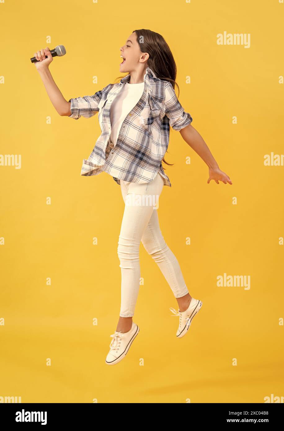 teen girl having fun at karaoke. girl singing karaoke with microphone ...