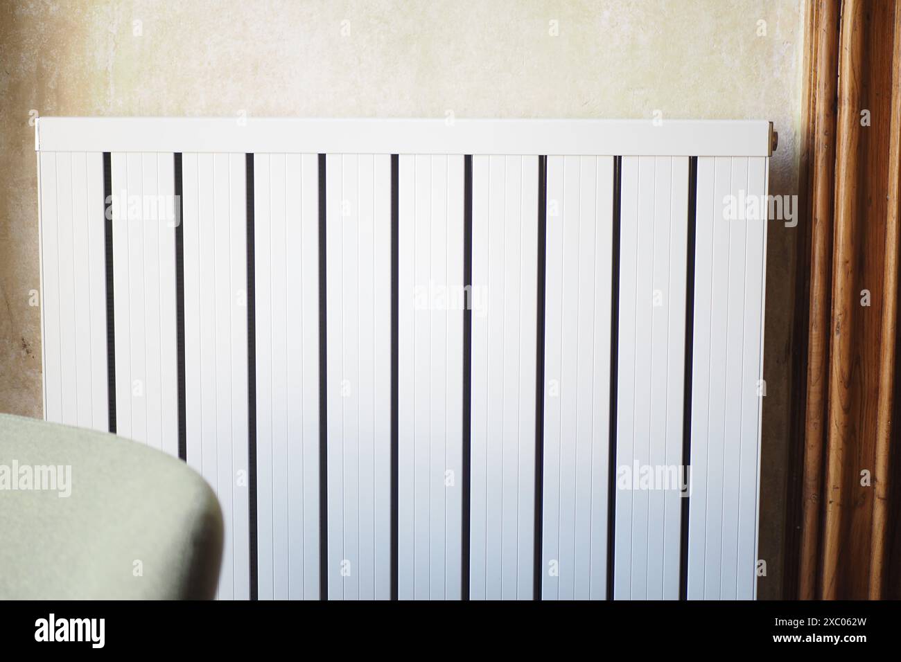 White radiator on grey white wall. apartment heating installation ...