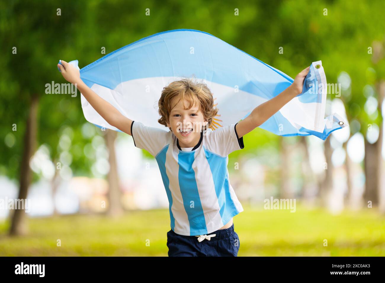 Child running with Argentina flag. Happy excited Argentinian kid fan ...