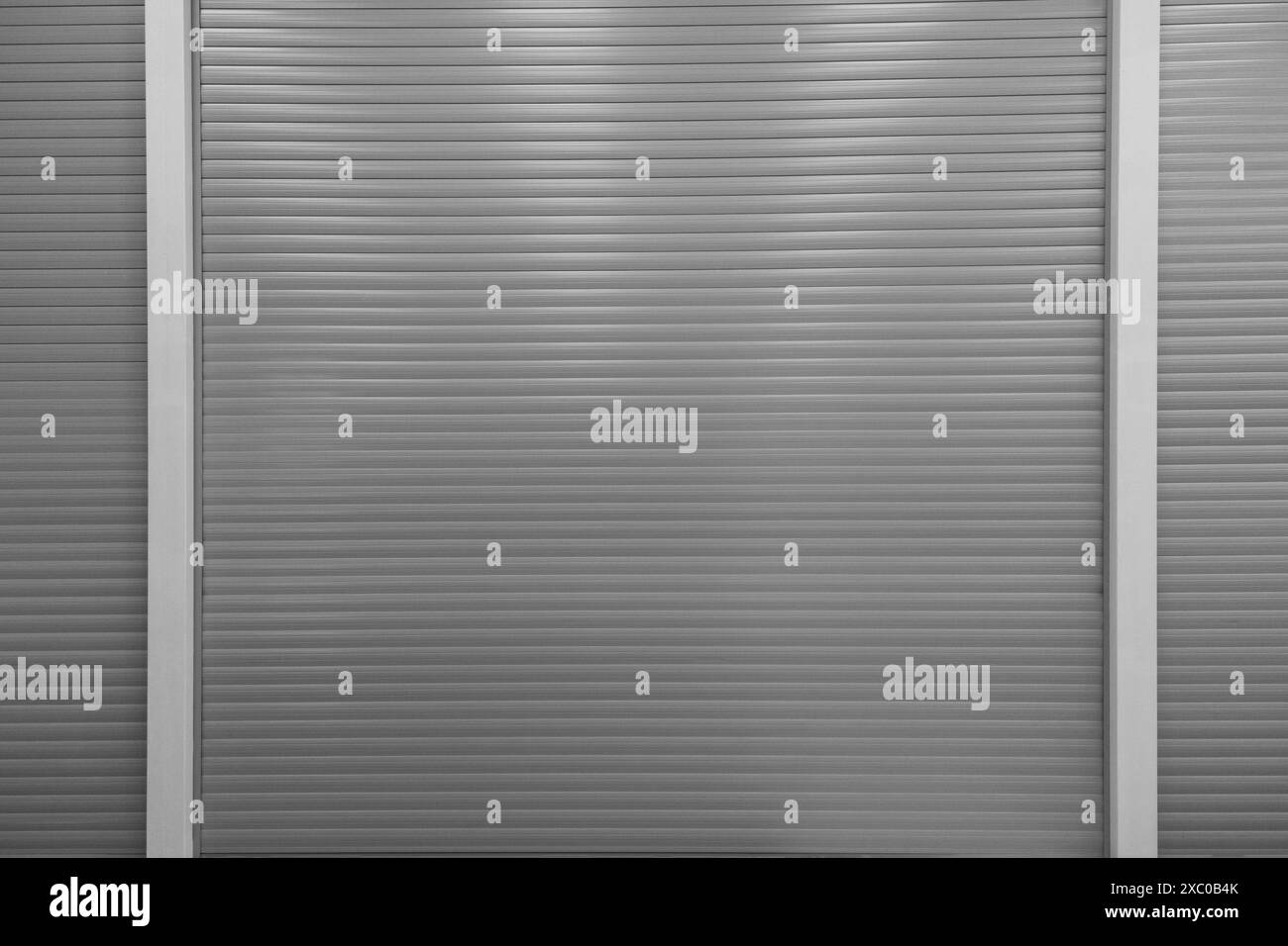 Closed metal rolling shutters on a contemporary building, ensuring ...