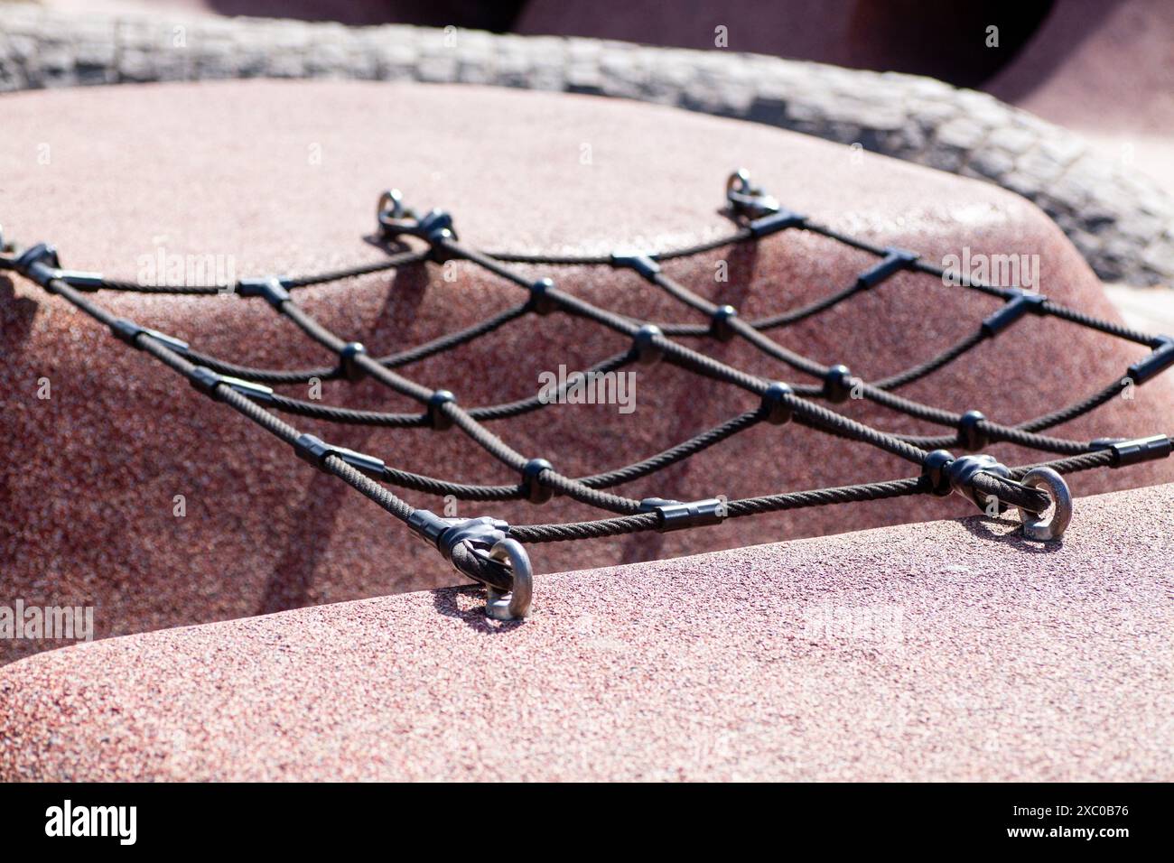 Close-up of a climbing net on a playground structure, highlighting the ...