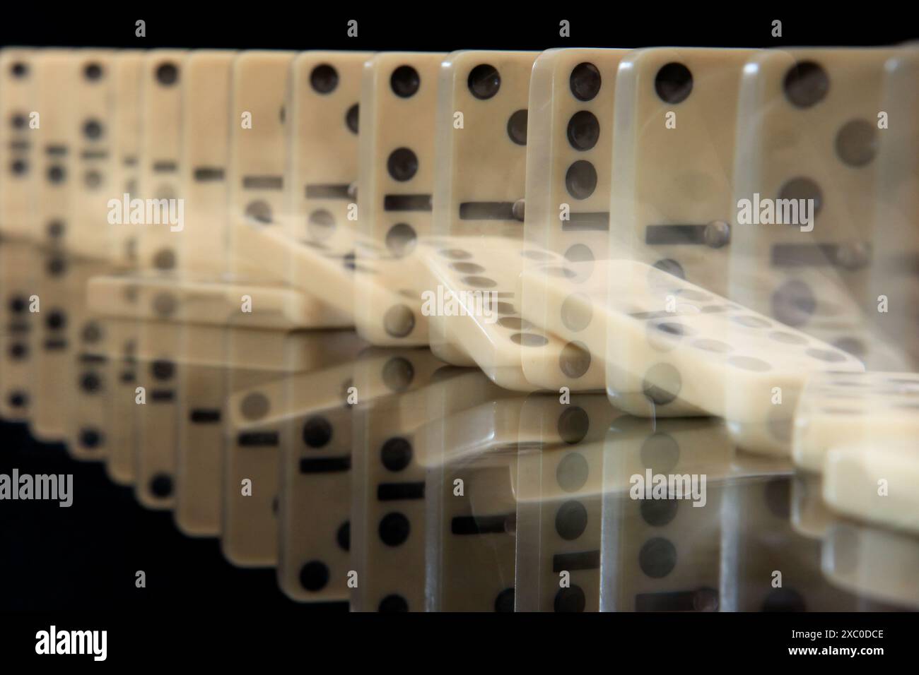 Dominoes falling in a row. Domino effect concept Stock Photo - Alamy