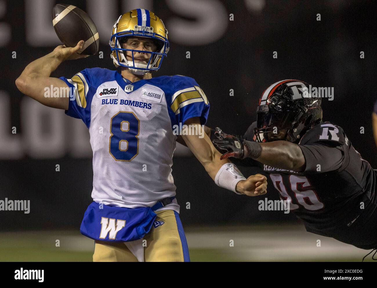 Ottawa, Canada. 13 Jun 2024. Zach Collaros (8) of the Winnipeg Blue Bombers and Michael ...