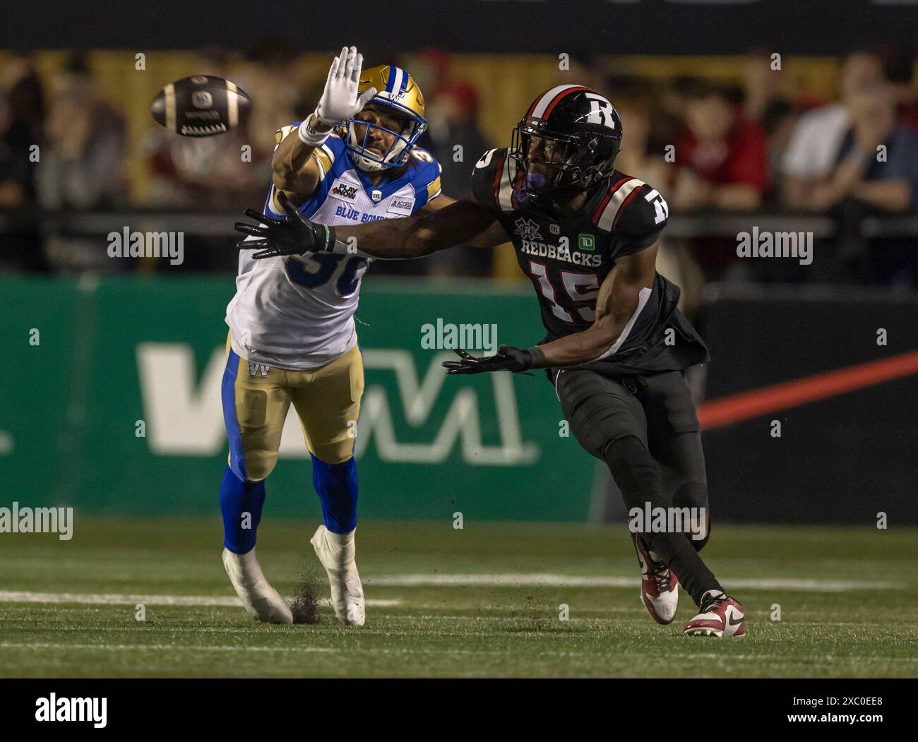 Ottawa, Canada. 13 Jun 2024. Tyrell Ford (30) of the Winnipeg Blue Bombers and Dominique Rhymes ...