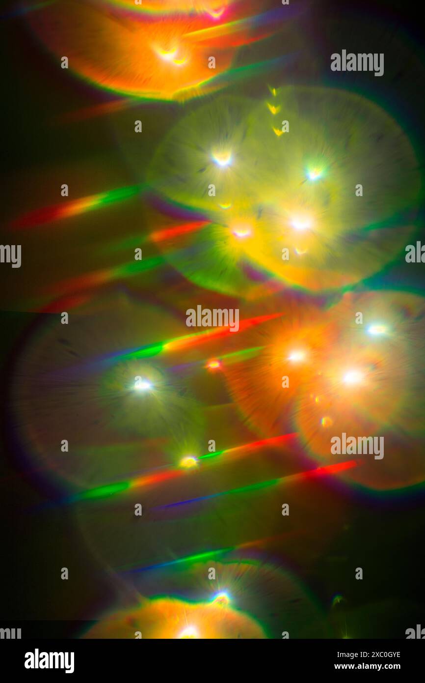 Out of focus Christmas lights, colourful with flare and rainbow colours ...