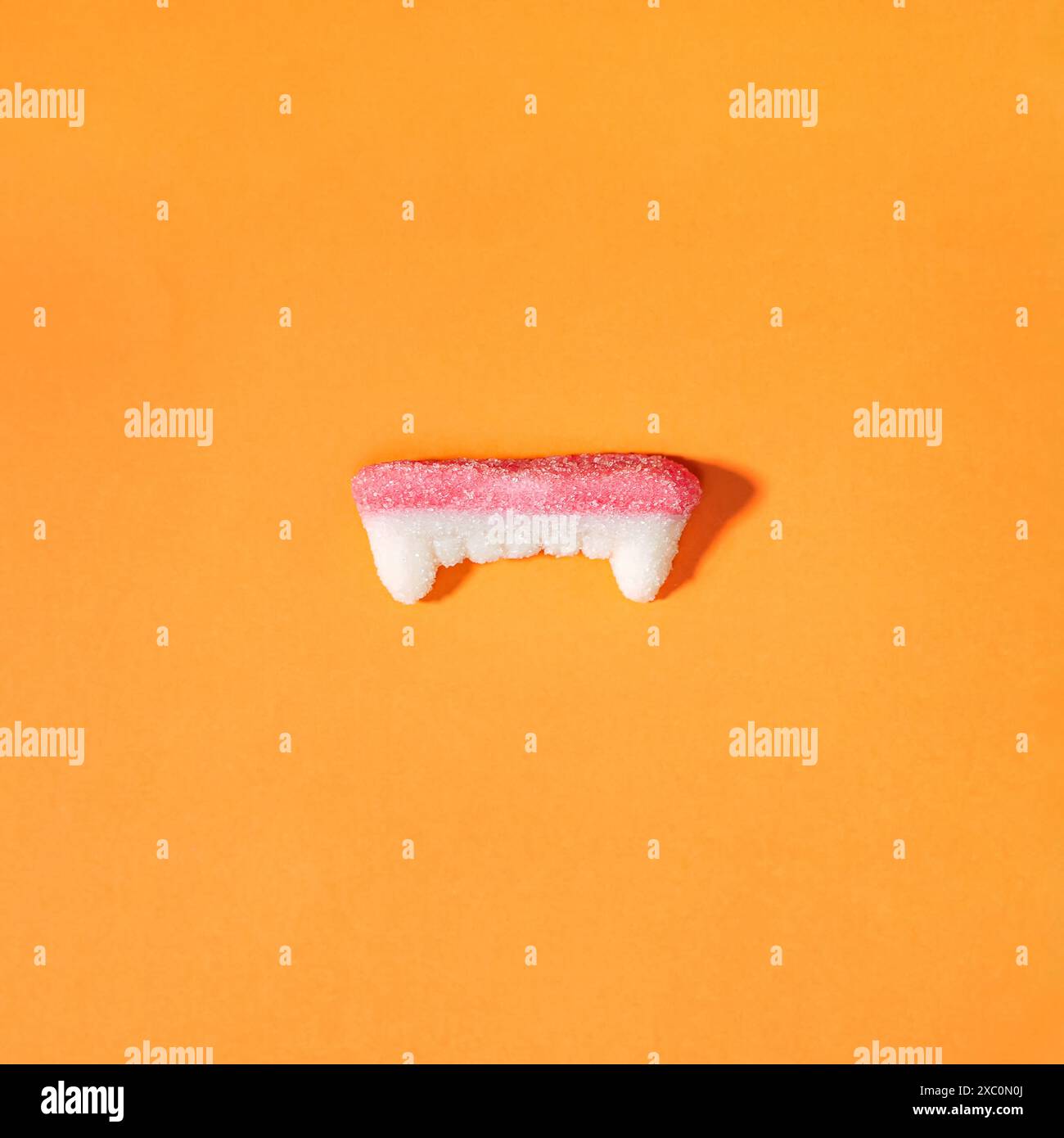 Gummy vampire teeth, sweet and sour Halloween candy isolated on orange ...