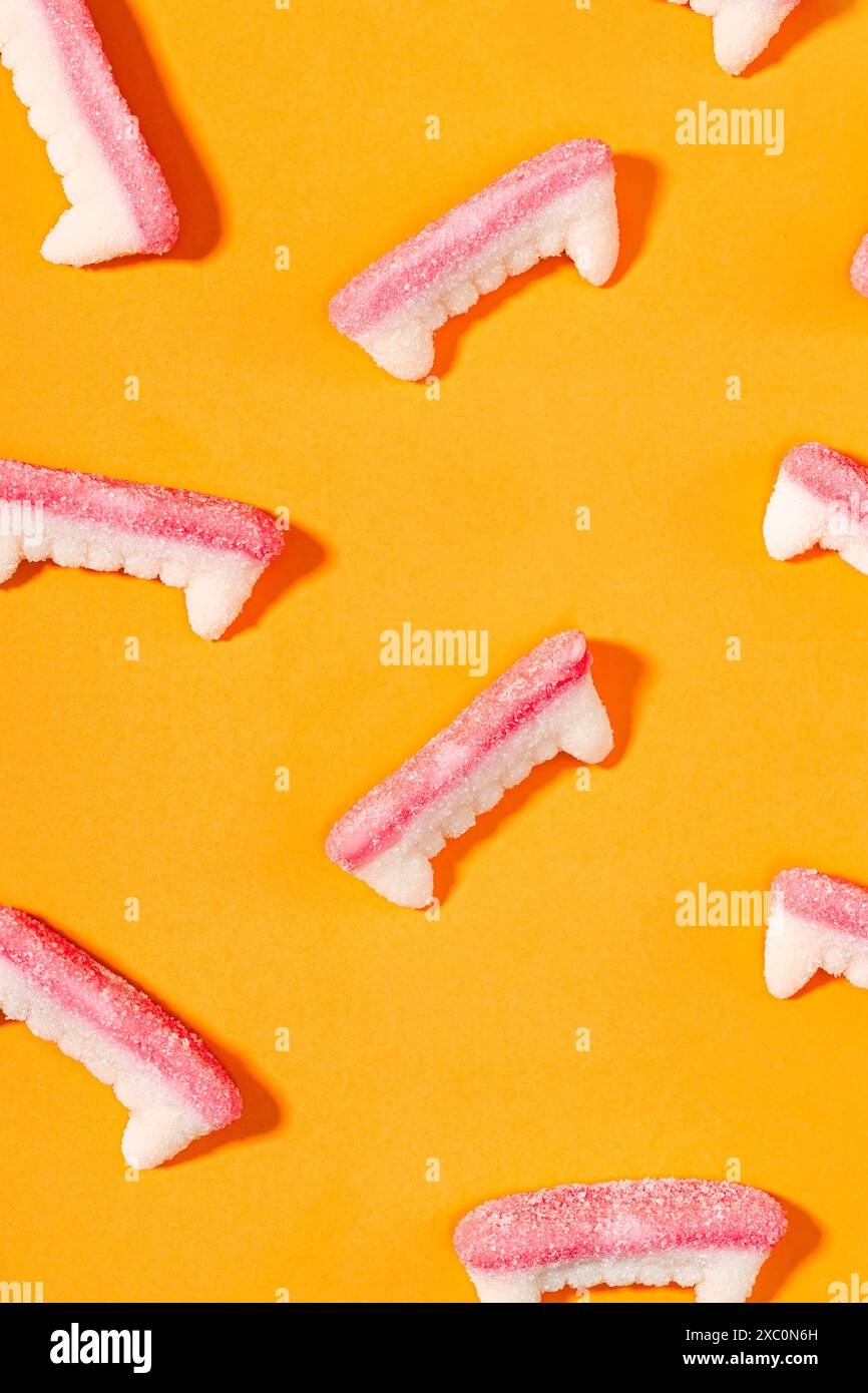 Creative Halloween background with gummy vampire teeth candy on bright ...