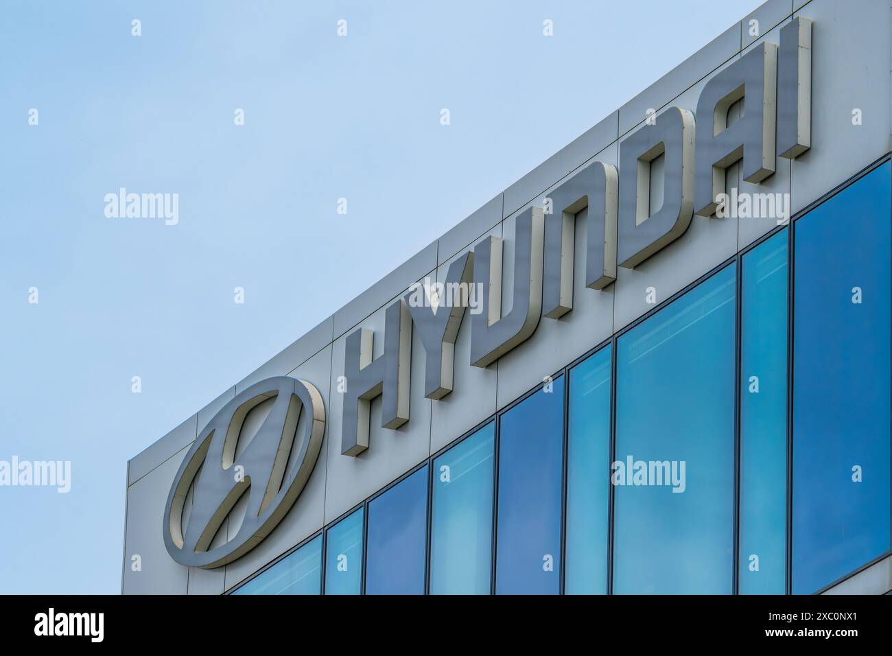 Close-up of the Hyundai logo on a modern office building against a ...