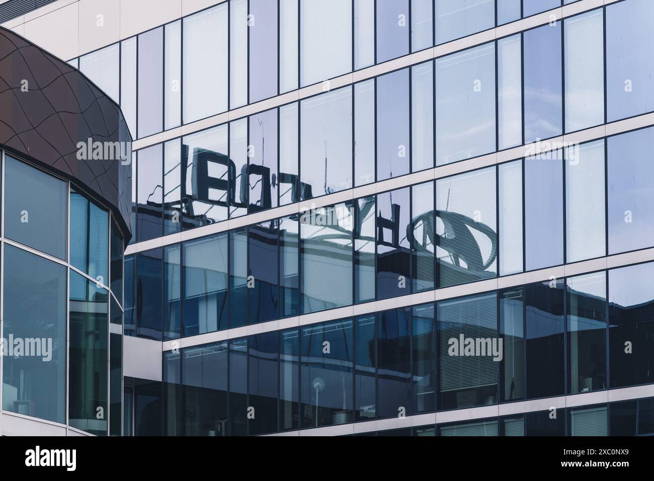 Modern office building with reflective glass windows showing distorted ... Modern office building with reflective glass windows showing distorted ...