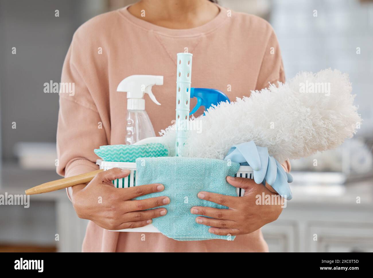 Hands, woman and basket with cleaning tools for housekeeping service ...