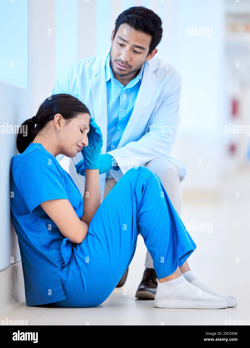Stress, crying and doctor comfort girl nurse on hospital floor with ...