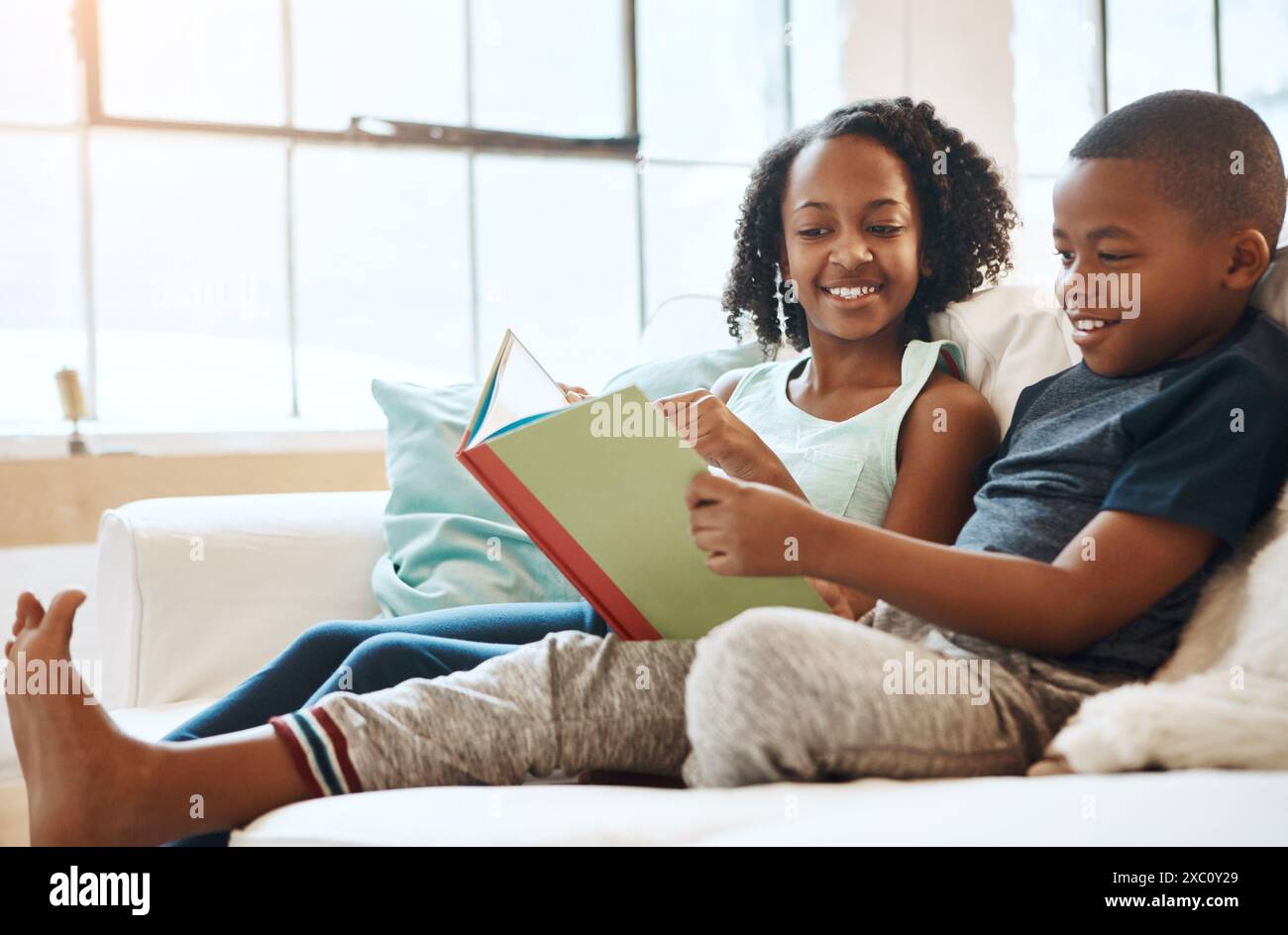 Children, boy and reading book on sofa house for knowledge, bonding or ...
