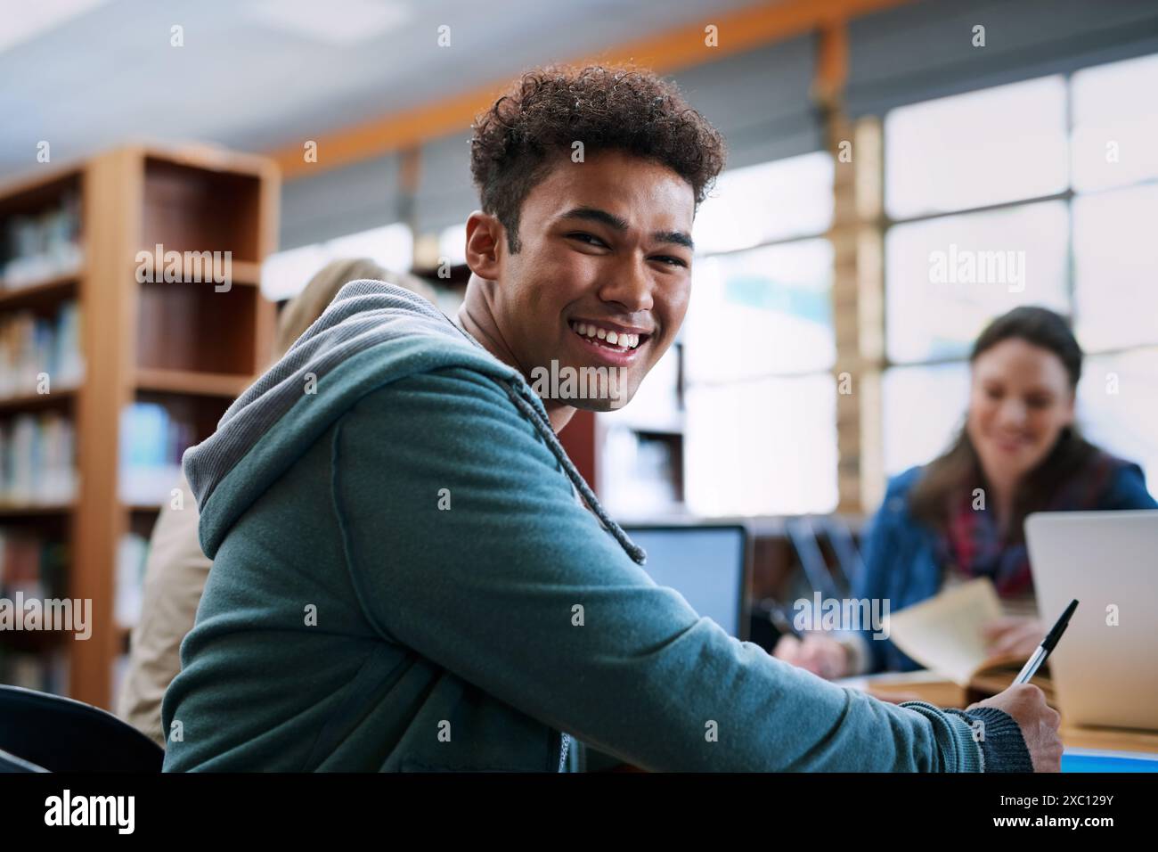 University student, man and happy with portrait in library for writing ...
