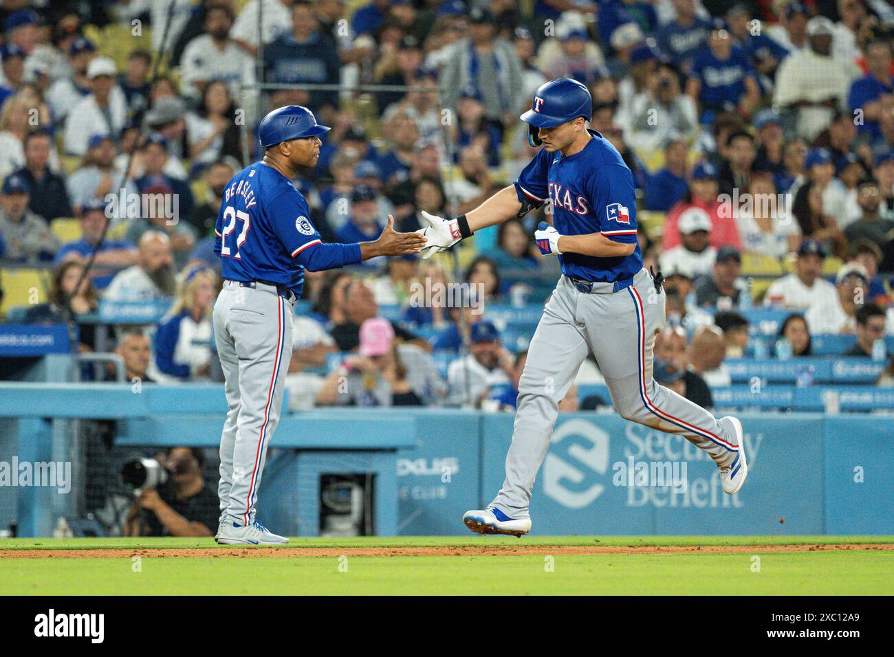 Texas Rangers third base coach Tony Beasley (27) congratulates ...