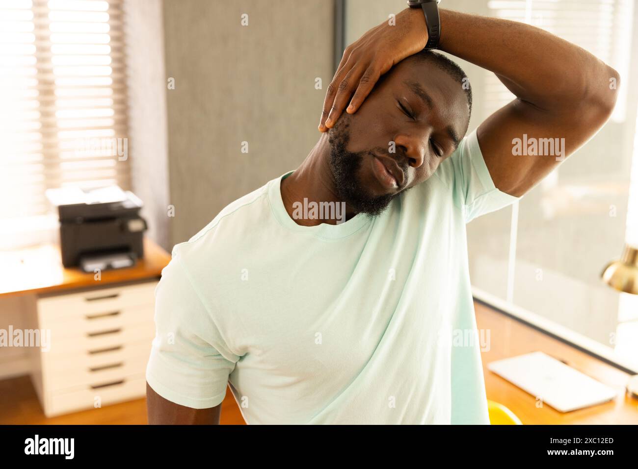 Fit African American man working out stretching neck, exercising ...