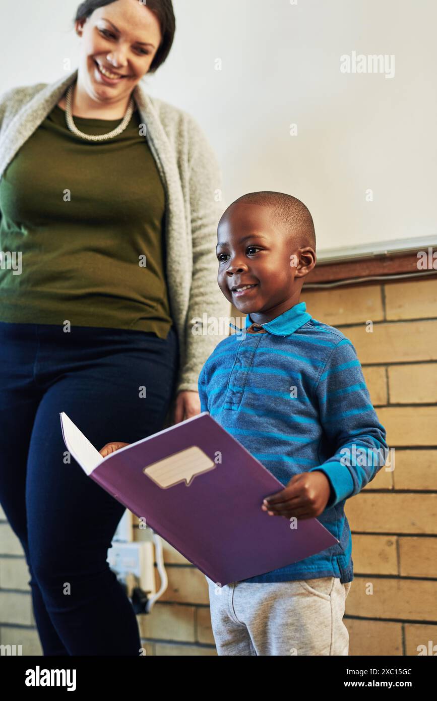 School, teacher or boy with book for presentation in classroom, help ...