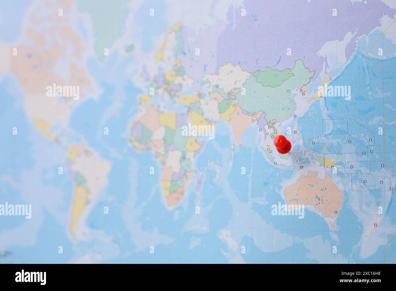 A world map with a red pushpin marking a location in Southeast Asia ...