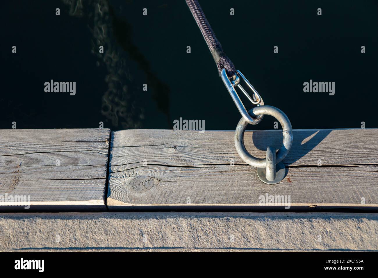 Mooring ring for boats in the port with carbine and black rope from the ...