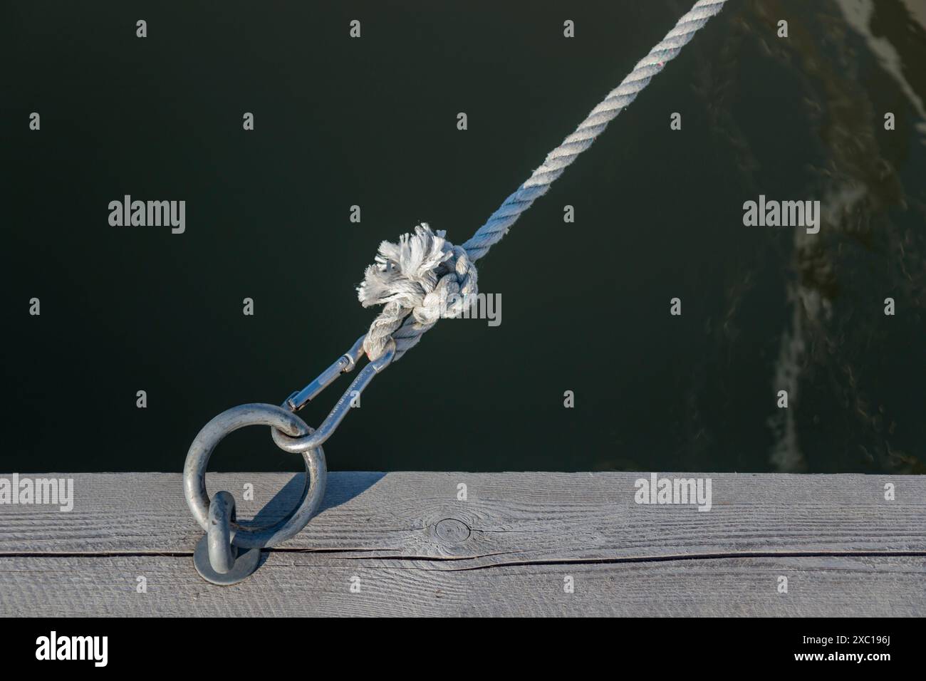 Mooring ring for boats in the port with carbine and black rope from the ...