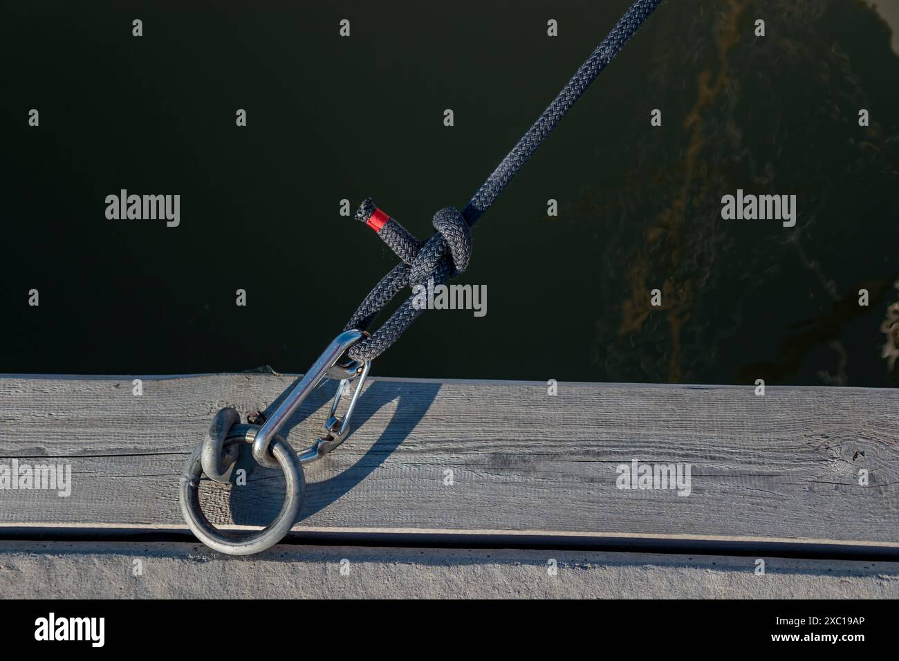 Mooring ring for boats in the port with carbine and black rope from the ...