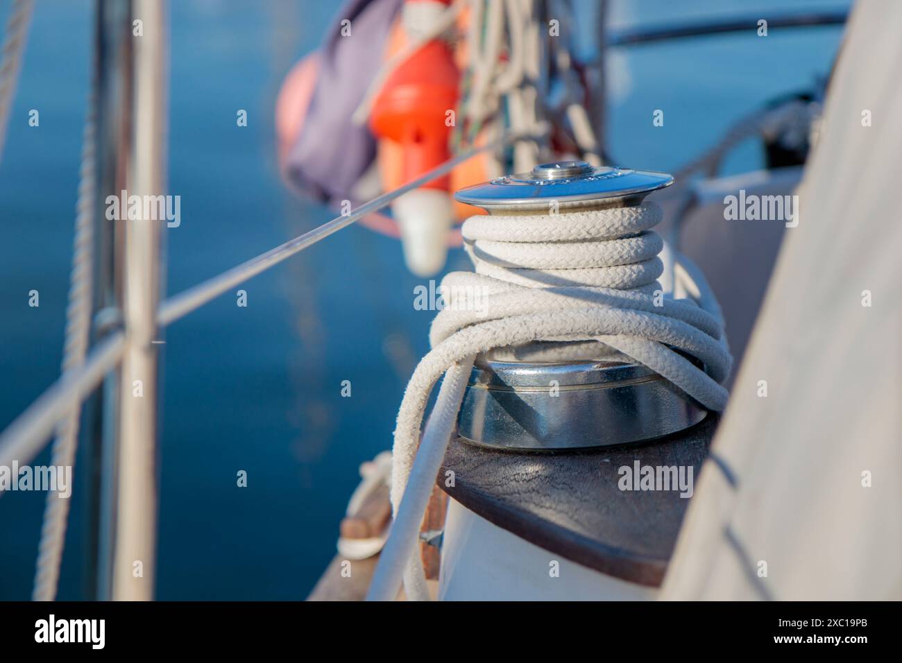 Sailboat winch with rope on yacht deck. Detail, low depth of focus ...