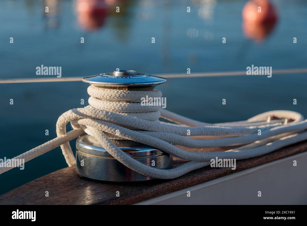 Sailboat winch with rope on yacht deck. Detail, low depth of focus ...