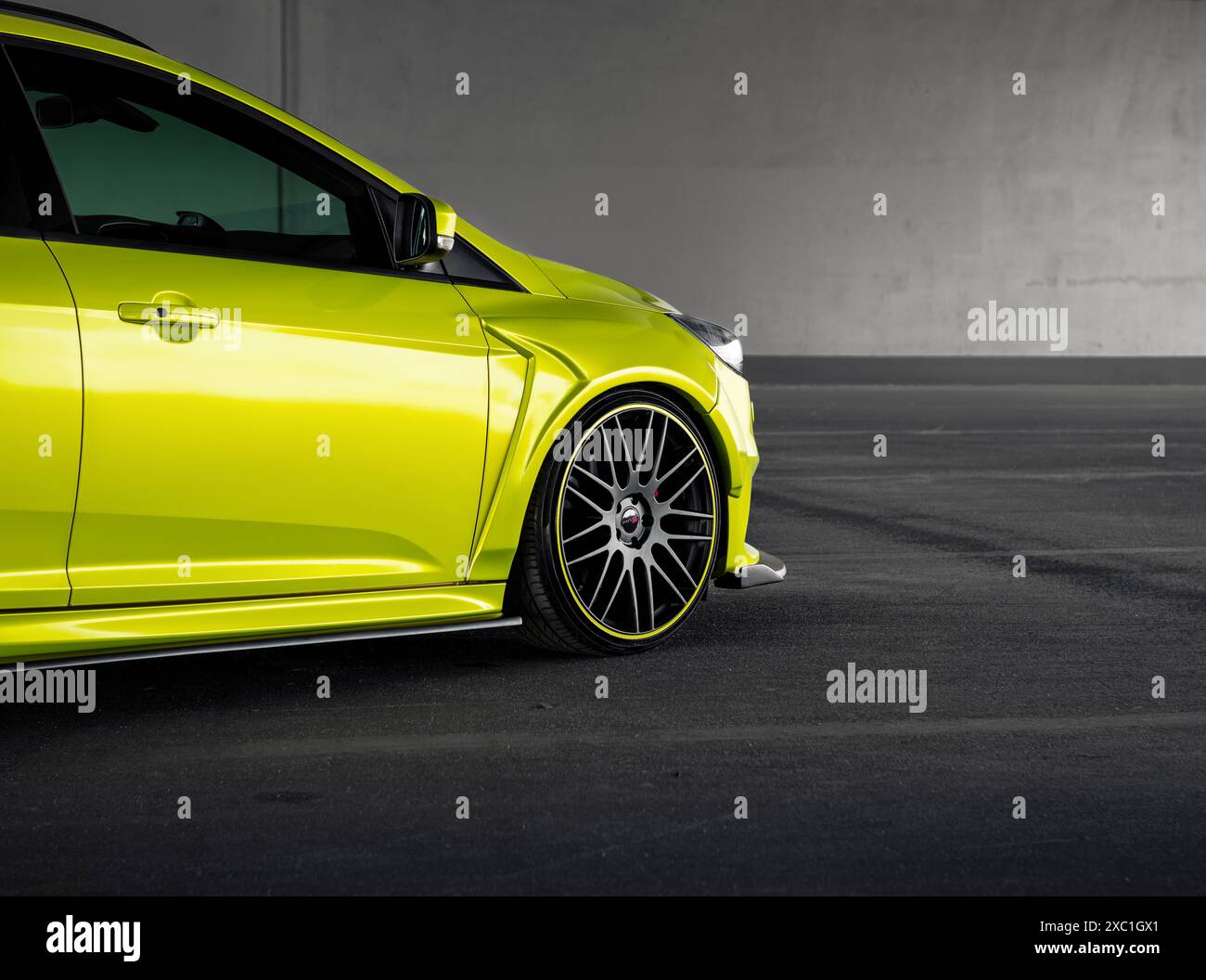 Front wheel and fender of lime green car. Close-up view of modified of ...