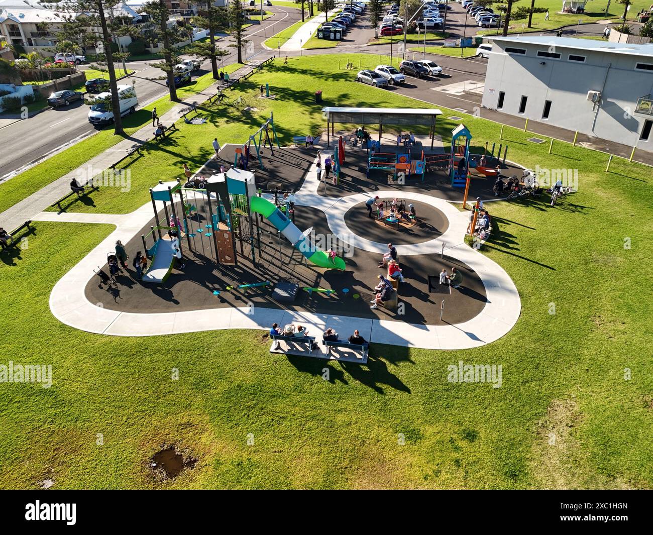 An aerial view of a vibrant playground with children and parents ...