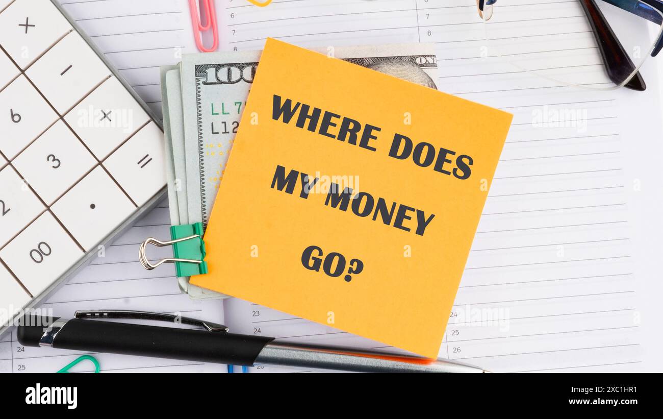 words Where does my money go. Business concept on a yellow sticker next ...