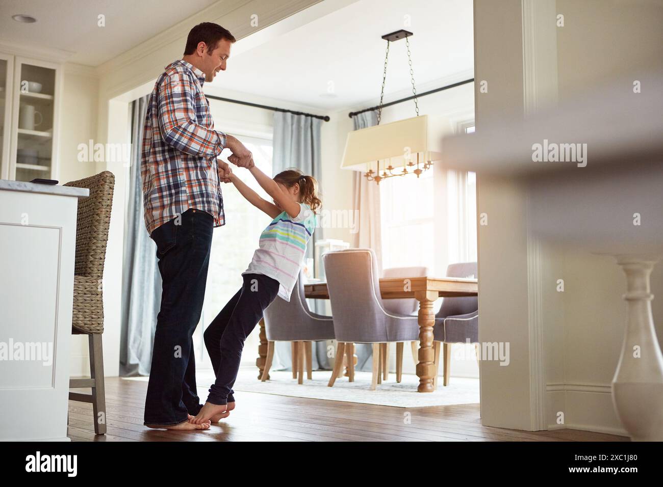 Dad, girl or dancing in home on feet together, growth or development ...