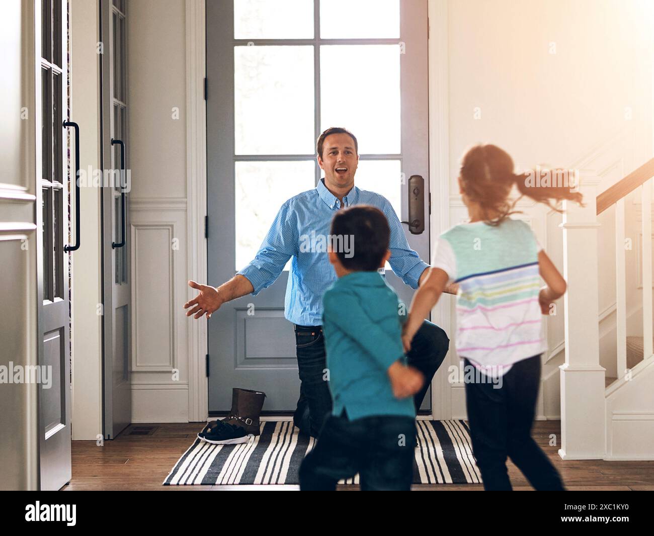 Hello, front door and dad with children hug in home for greeting ...