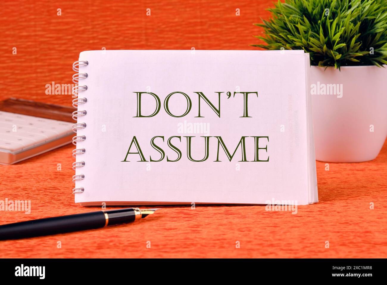 don't assume concept, Don't assume - words on a white notebook on an ...